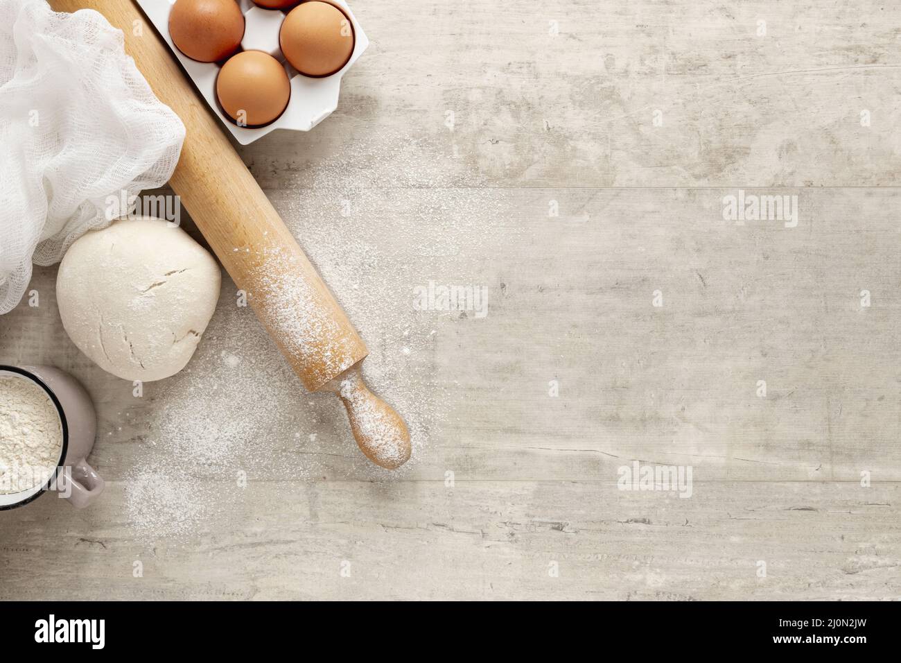 Dough eggs kitchen roller with copy space Stock Photo - Alamy