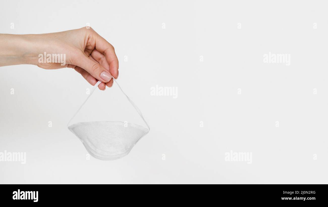 Close up hand holding mask Stock Photo - Alamy