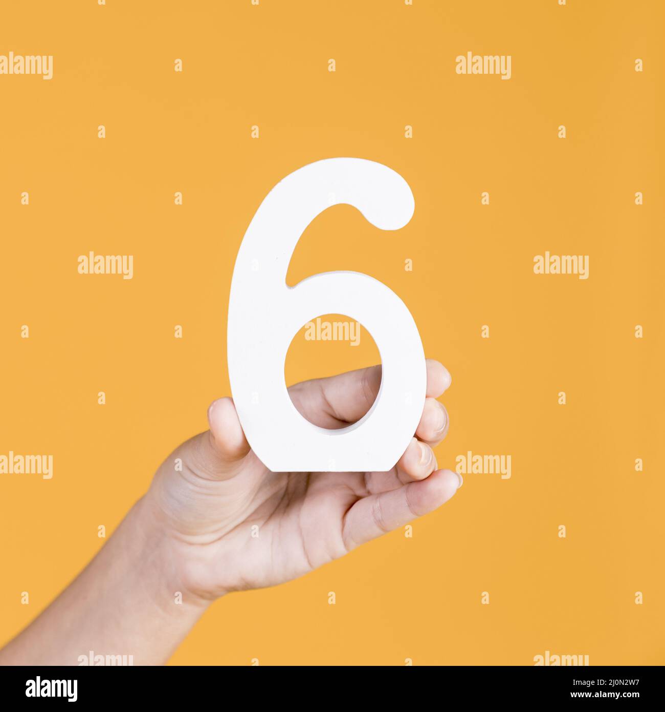 Close up hand holding number 6 Stock Photo - Alamy