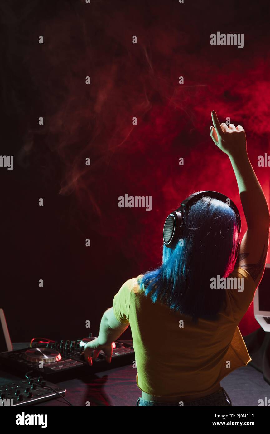 Back view dj woman setting party mood Stock Photo - Alamy