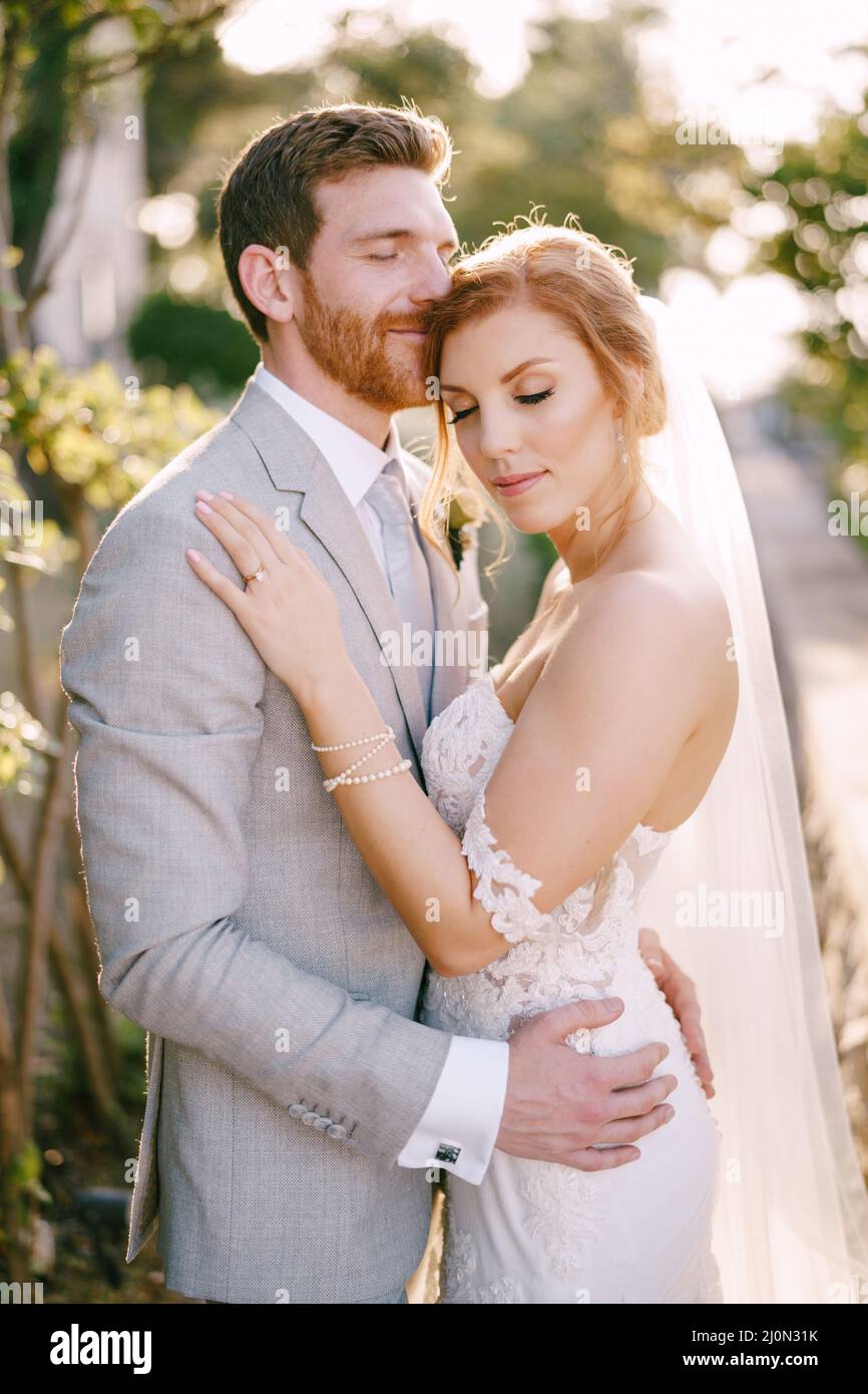 Groom hugs bride standing hi-res stock photography and images - Alamy