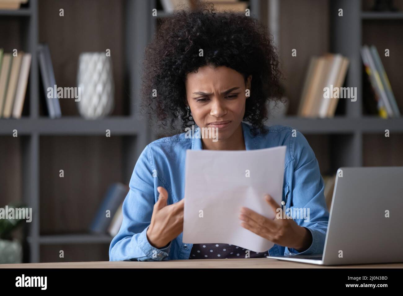 Annoyed frustrated African student girl receiving paper letter Stock ...