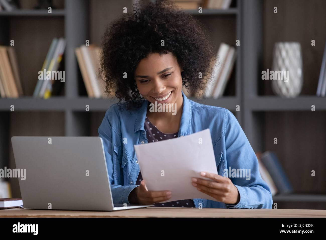 Satisfied student girl receiving paper admission letter from school ...