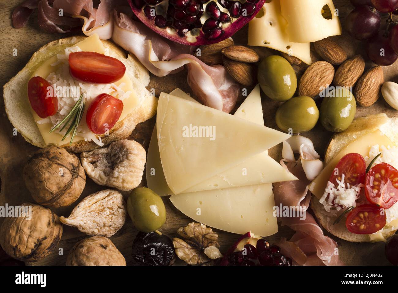 Delicious cheese with tomatoes composition table Stock Photo - Alamy