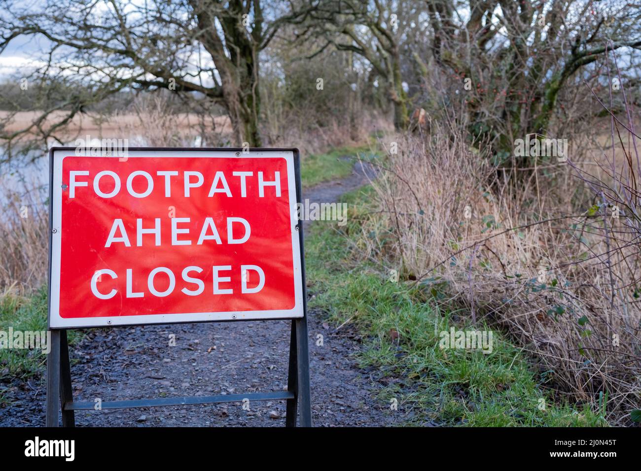 Red footpath ahead closed warning sign on a countryside trail Stock ...