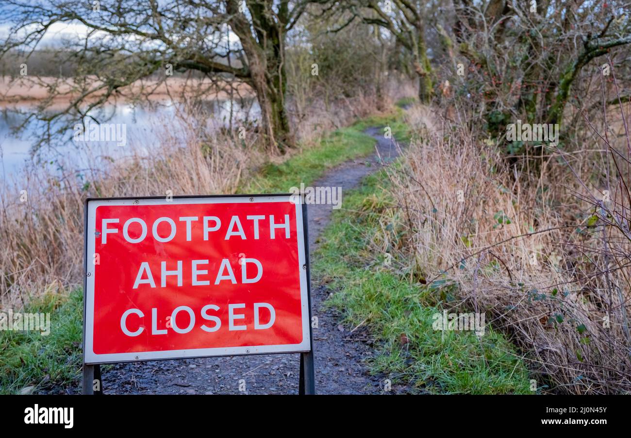 Red footpath ahead closed warning sign on a countryside trail Stock ...