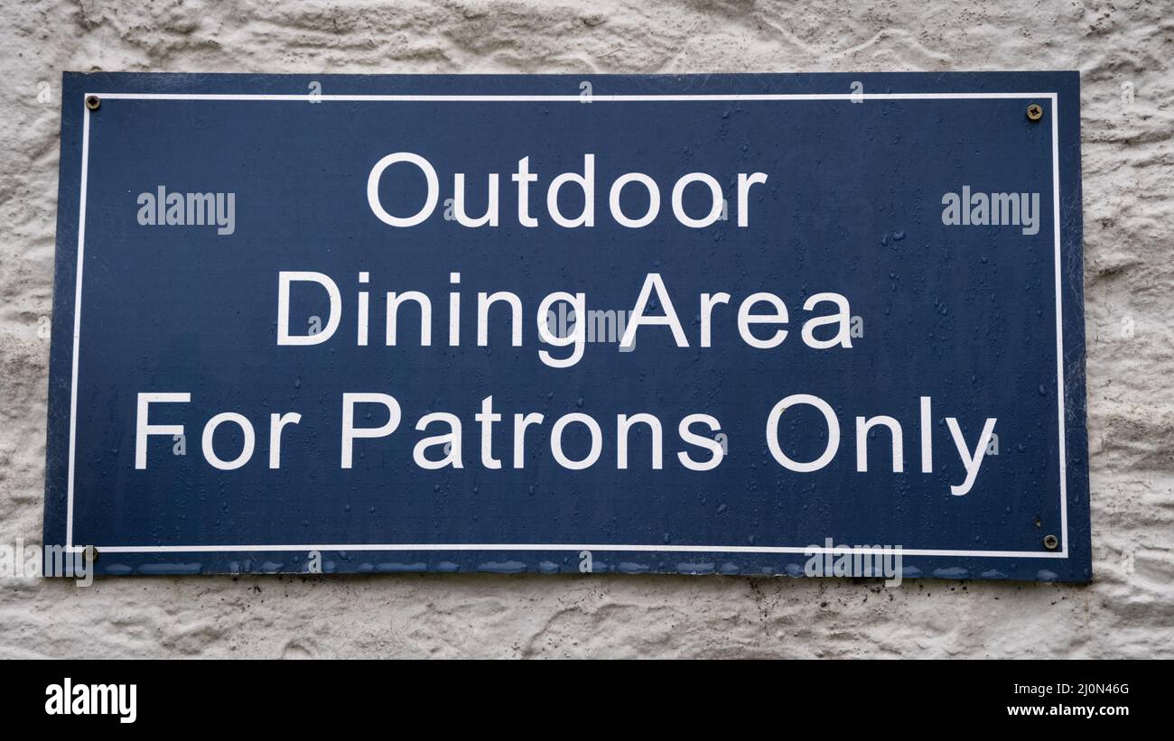 Blue Outdoor Dining Area for Patrons Only Wall Sign Stock Photo - Alamy