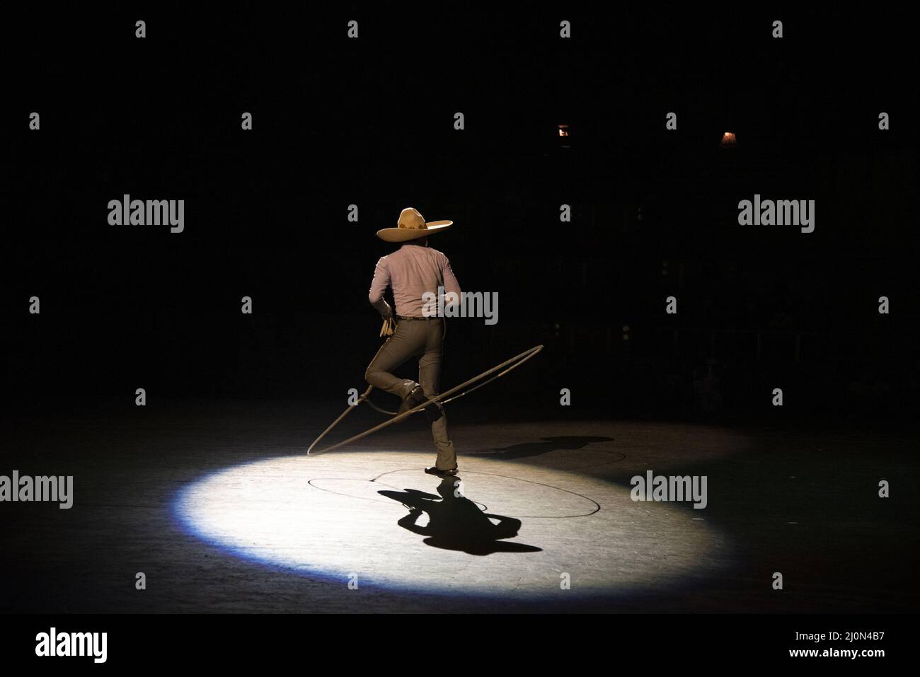 Unrecognizable man using a lasso in a dark studio background Stock ...