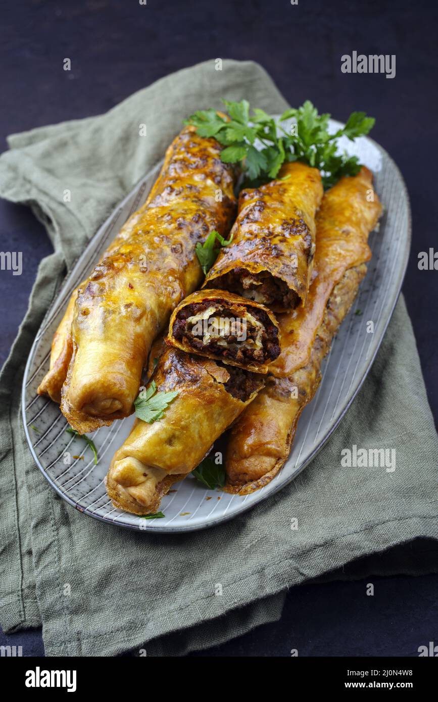 Traditional Turkish crispy sigara borek rolls with minced meat rolled ...