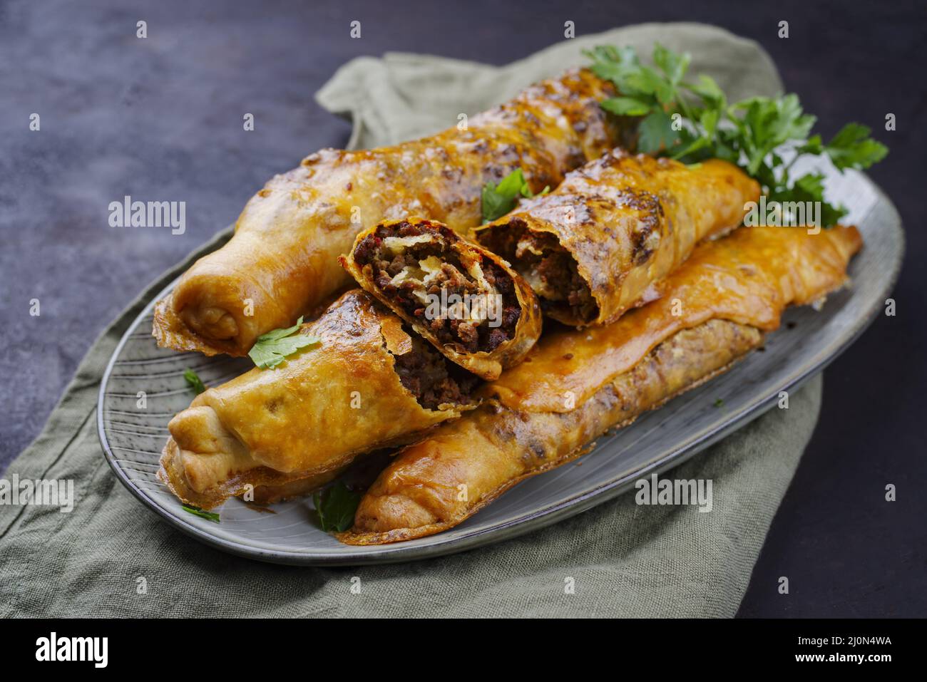 Traditional Turkish crispy sigara borek rolls with minced meat rolled ...