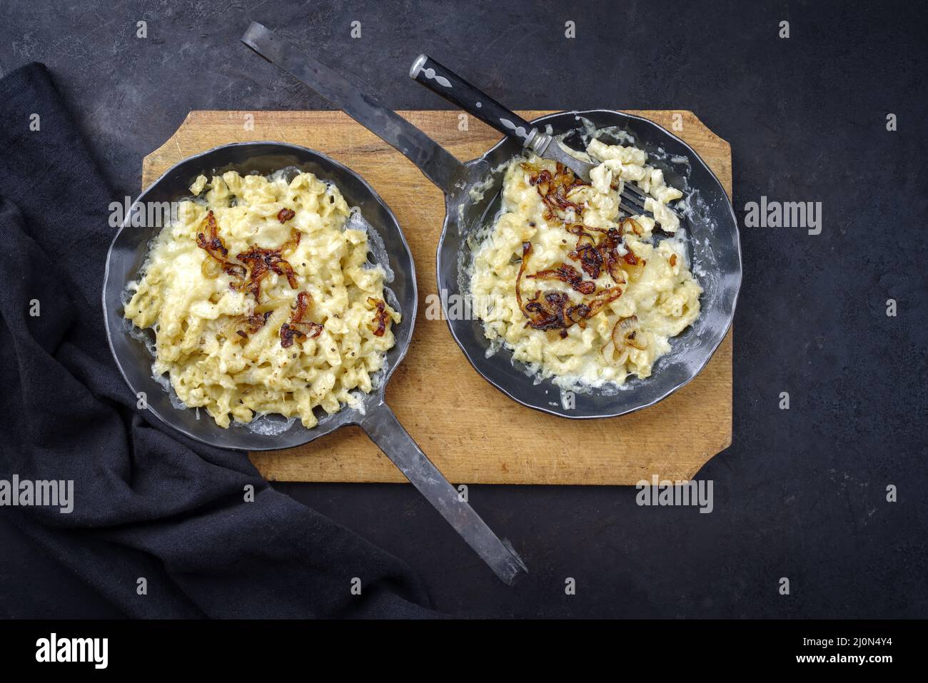 Traditional Swabian cheese spaetzle with fried onions served as top ...