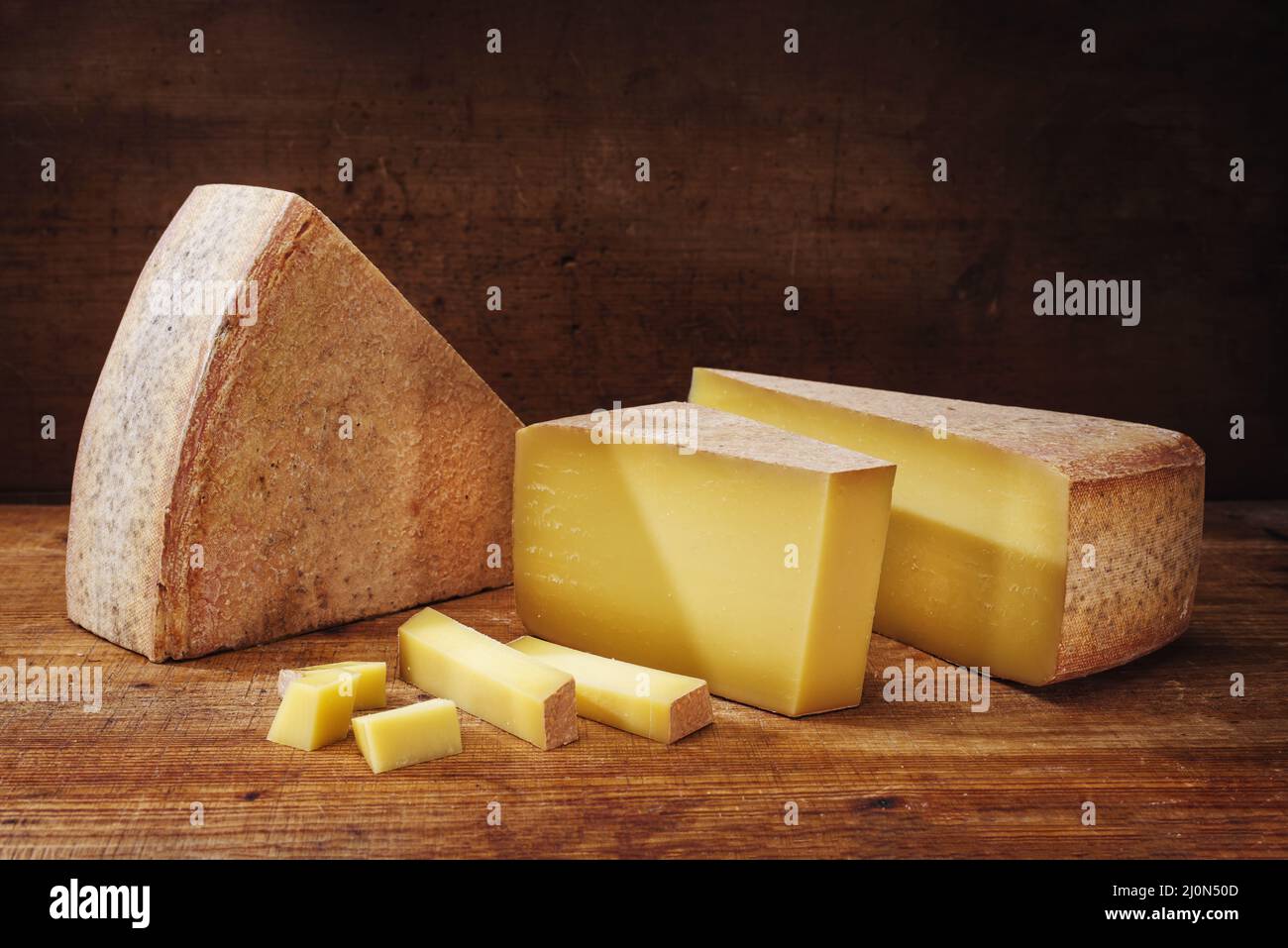 Traditional aged mountain cheese of the Alps offered as loaf and piece ...