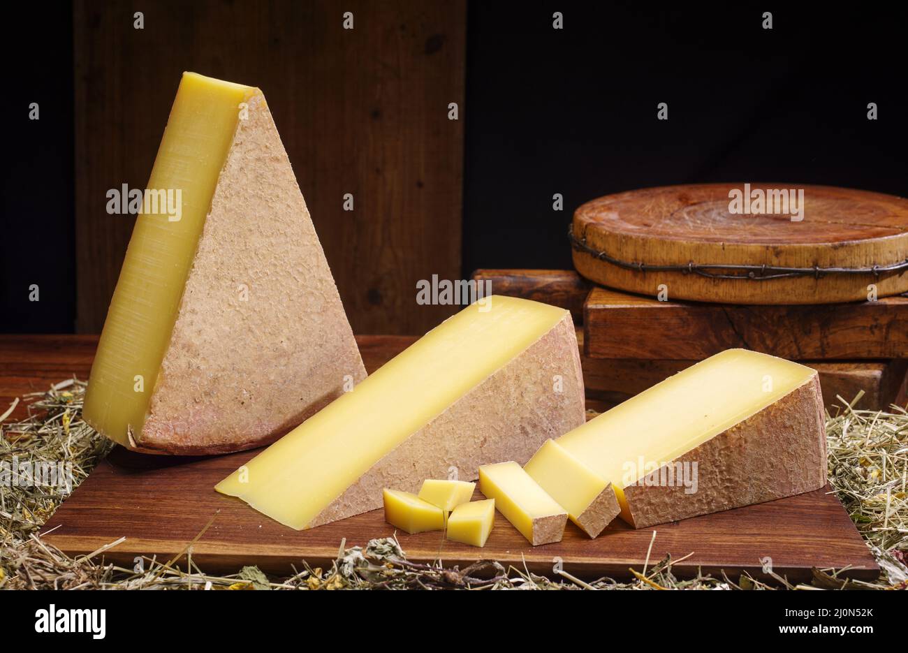 Traditional aged mountain cheese of the Alps offered as loaf and piece ...
