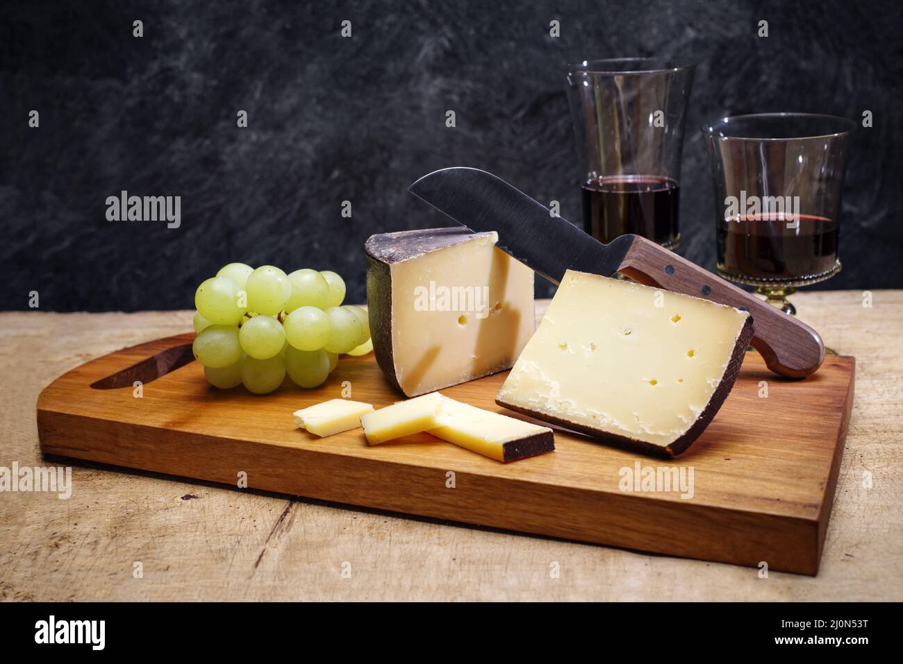 Modern style traditional aged mountain cheese of the Alps offered with ...
