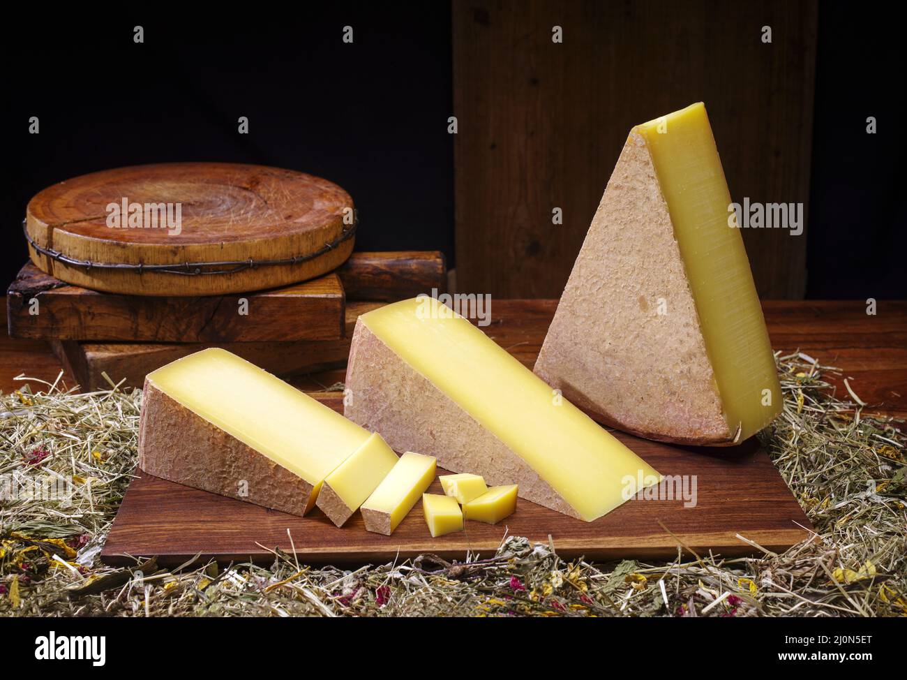 Traditional aged mountain cheese of the Alps offered as loaf and piece ...