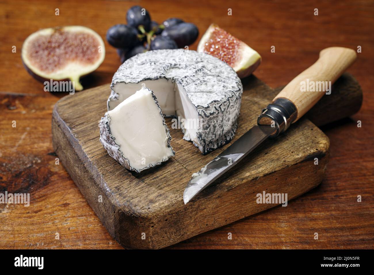 Traditional French Chevre goat milk cheese with fig and grapes offered ...