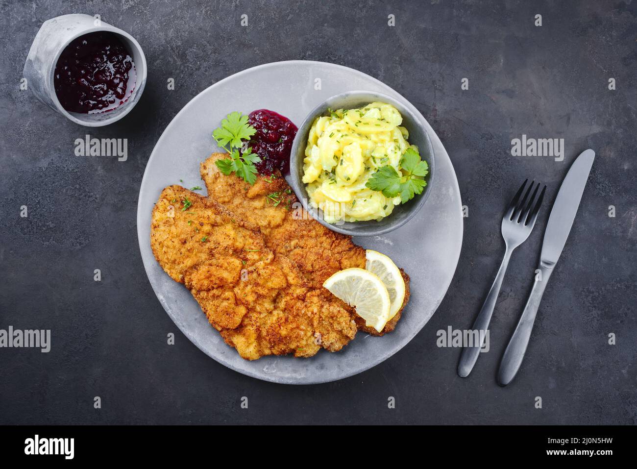 Traditional deep-fried schnitzel with potato salad Stock Photo - Alamy