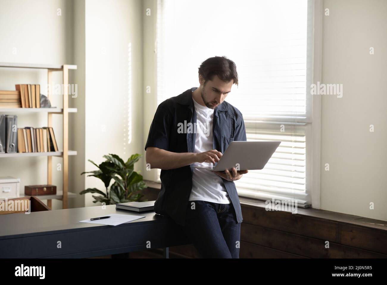 Business man in workplace standing hi-res stock photography and images ...
