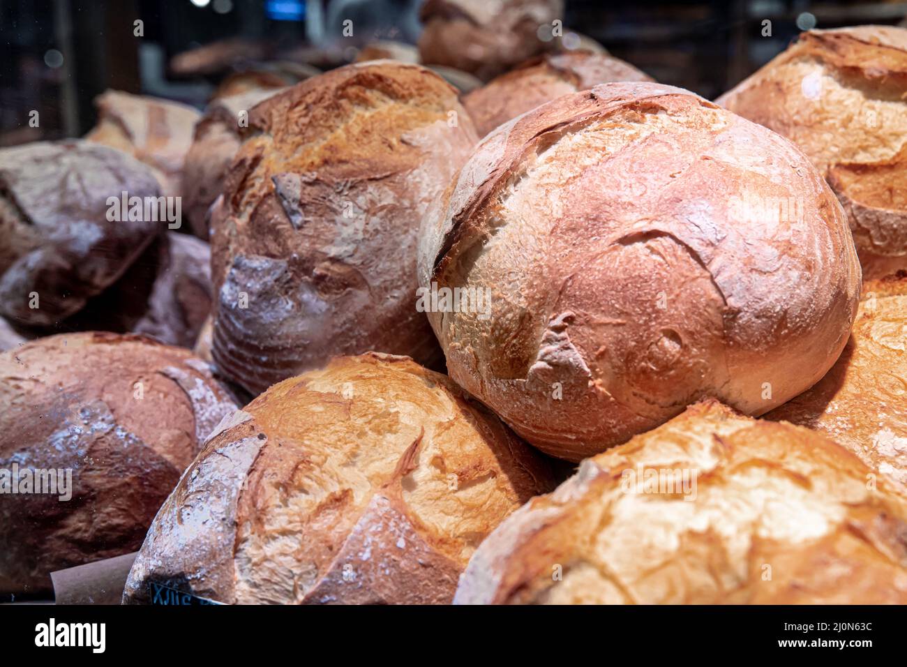 Large loaves of bread on the counter of a bakery Stock Photo - Alamy