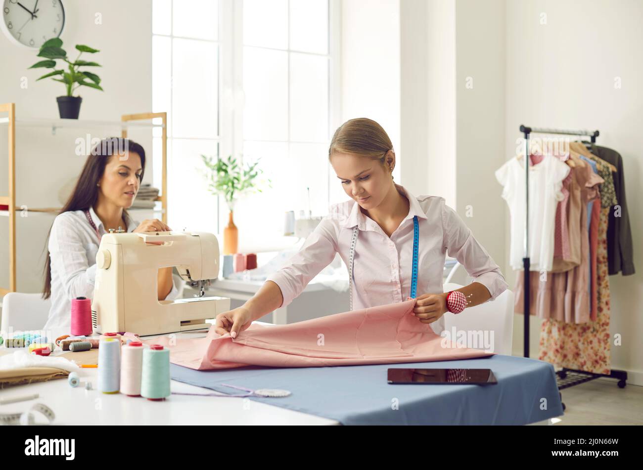 Women tailors work together in small own fashion atelier Stock Photo ...