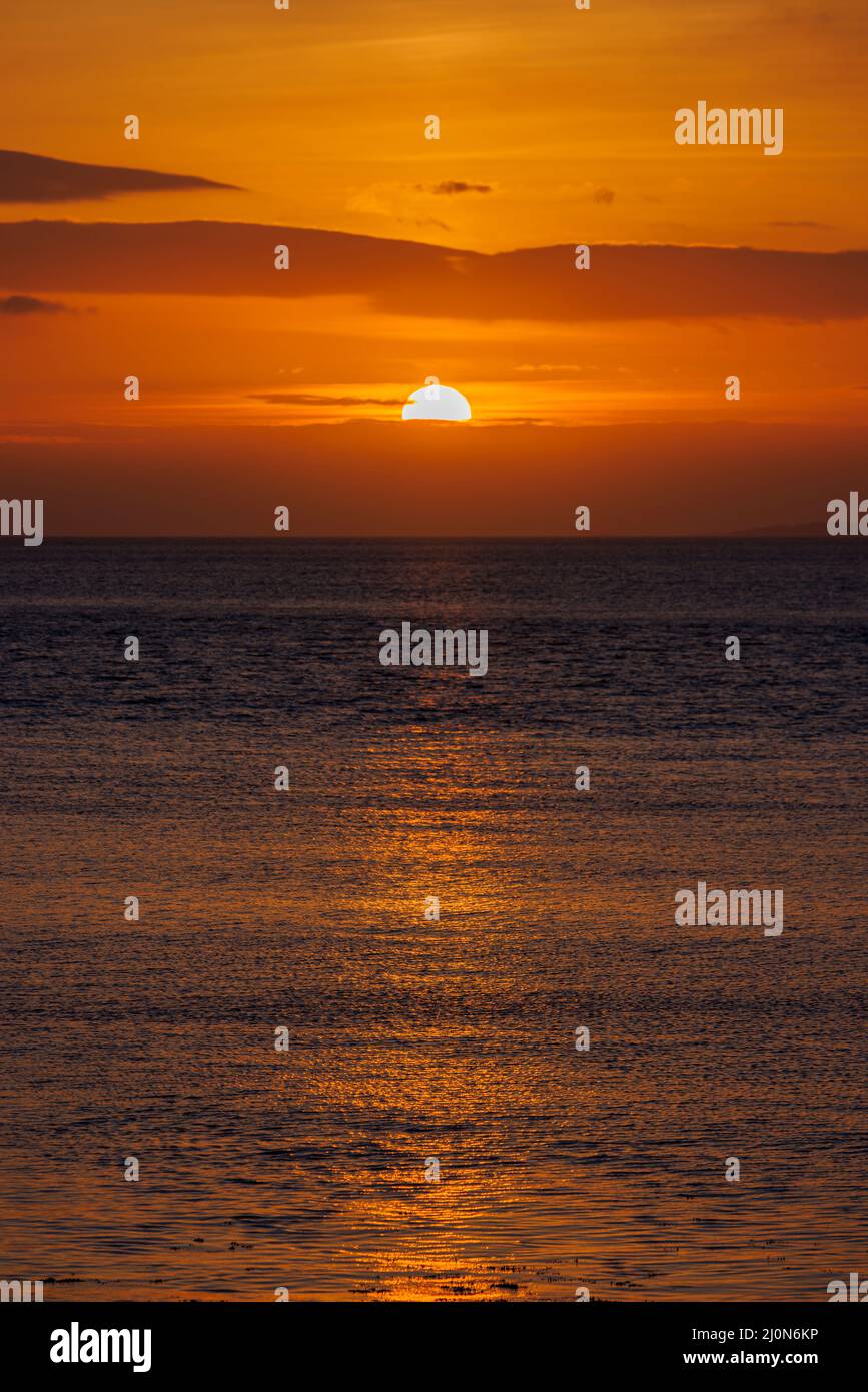 The setting sun lighting up the cloud cover Stock Photo - Alamy