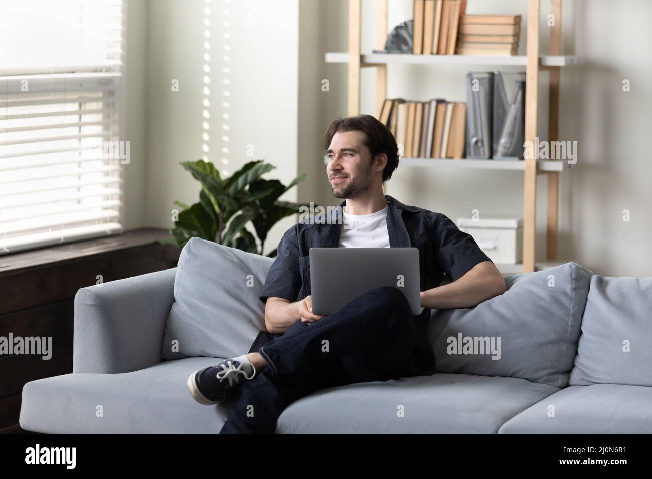 Dreamy pensive freelance man thinking over work project ideas Stock ...