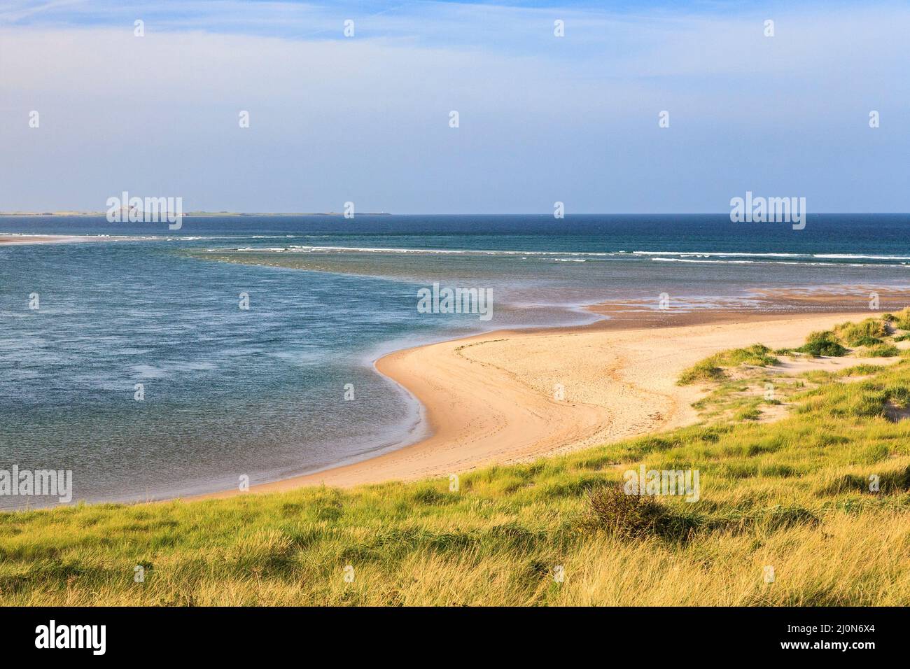 High tide at Budle Point on Budle Bay with Holy Island on the horizon ...