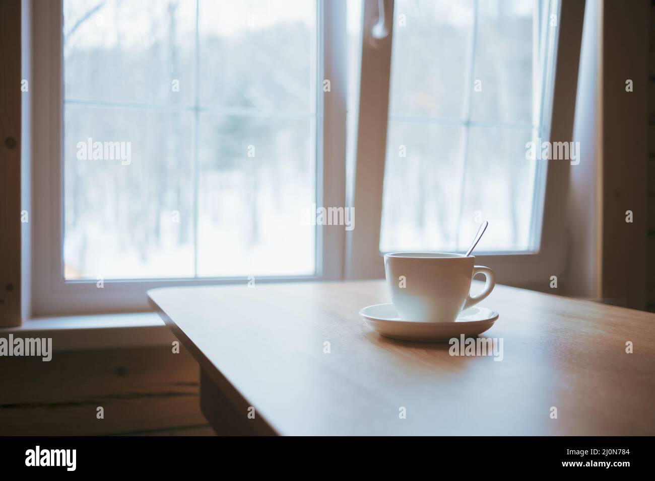 The cup is on the table in front of the window Stock Photo - Alamy