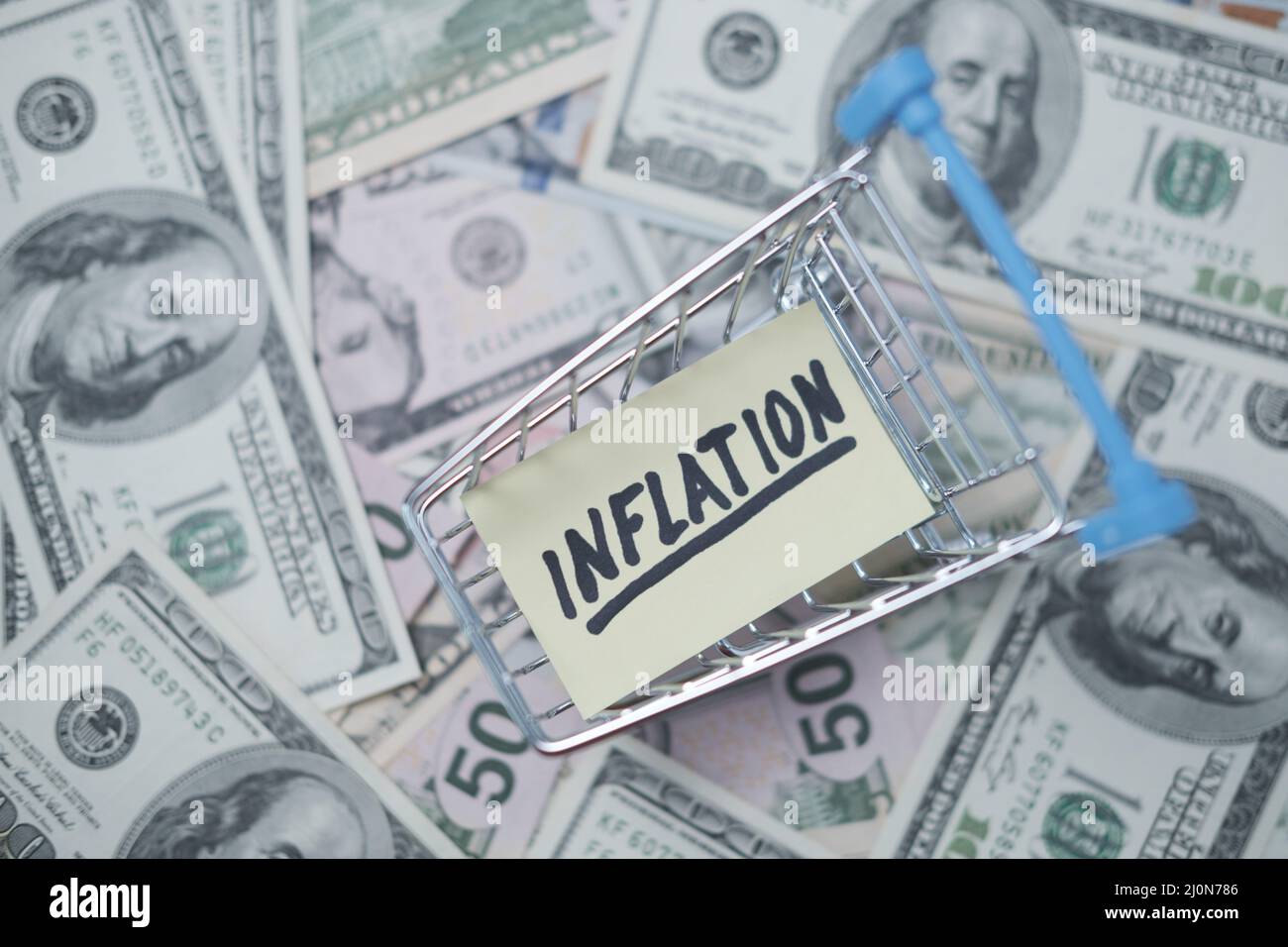 Shopping cart with inflation poster on a blurred background made of ...