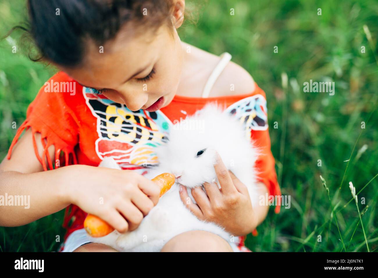 Children playing with pet rabbit hi-res stock photography and images ...