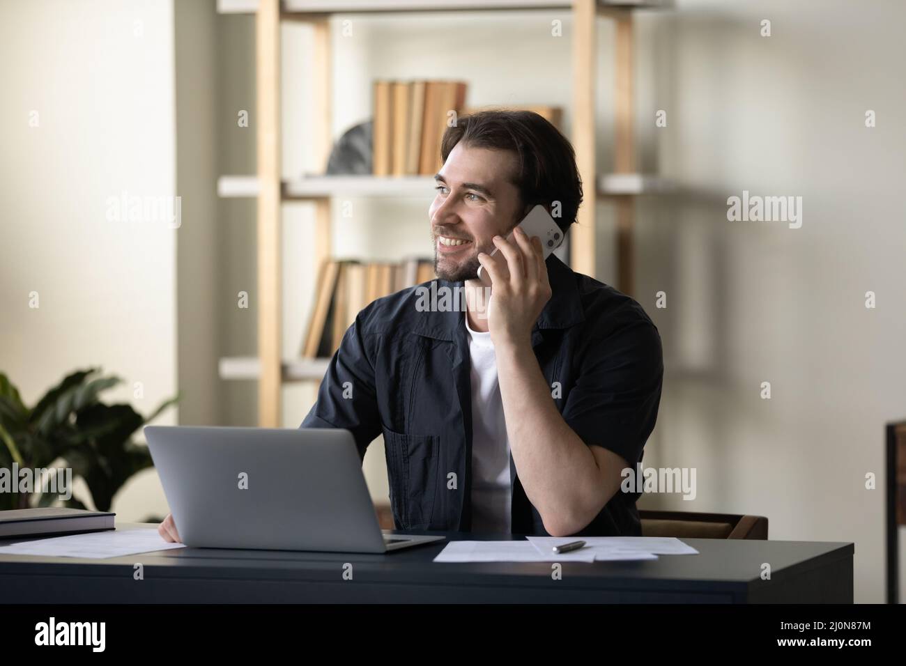 Happy handsome millennial businessman making phone call to client Stock ...