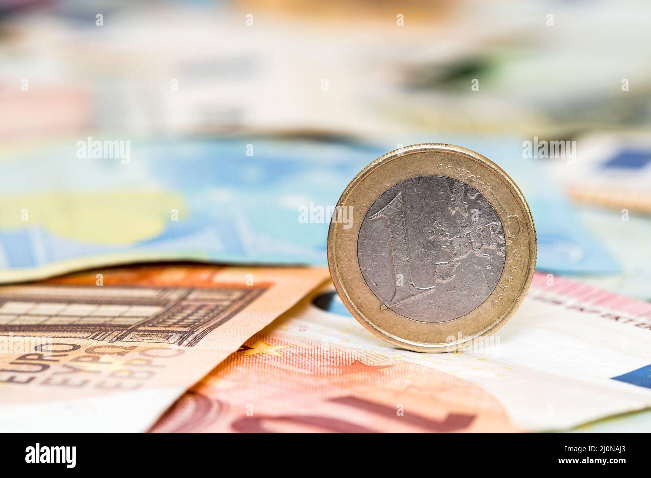 One euro coin and bills of euro banknotes Stock Photo - Alamy