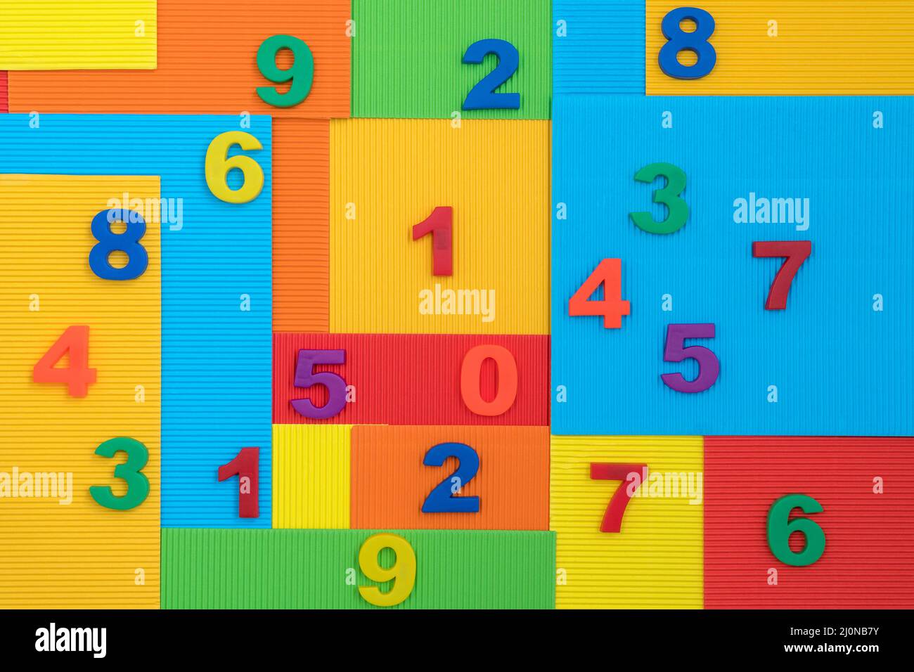 Plastic numbers on the colorful paper background Stock Photo - Alamy