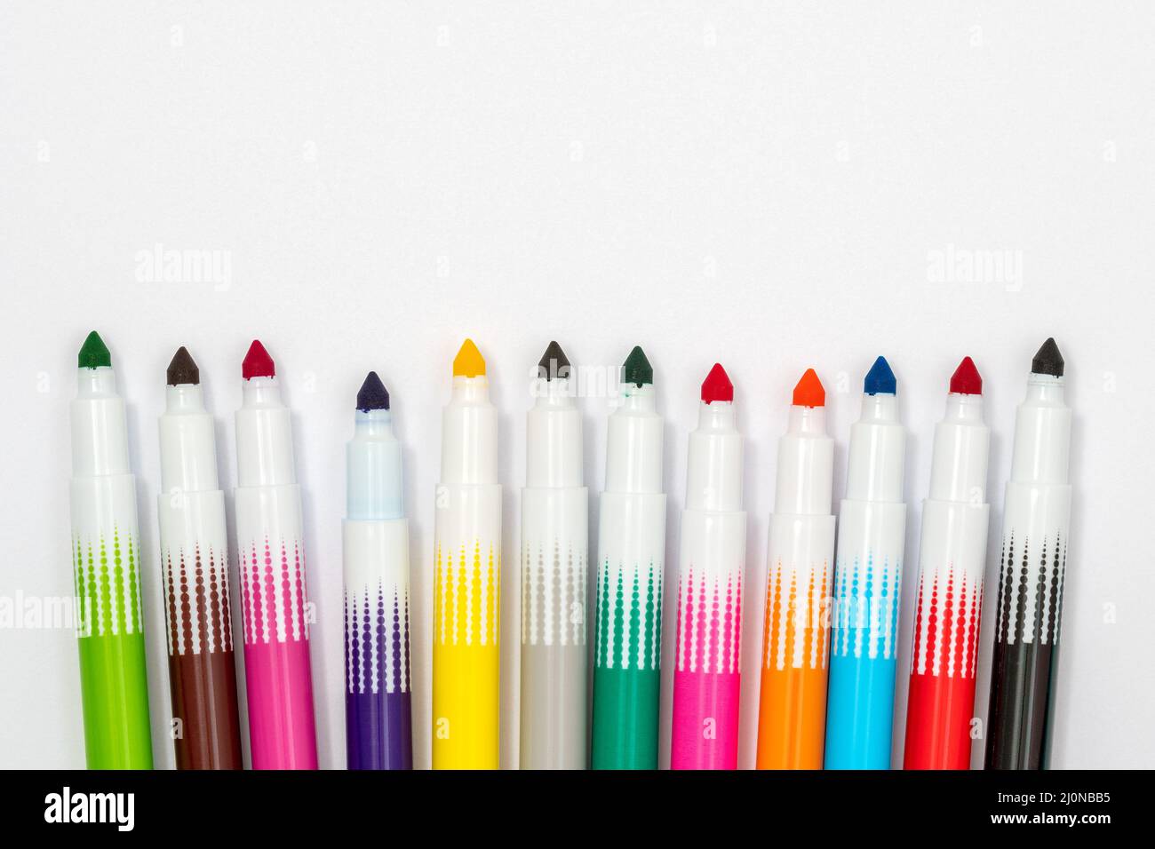 Felt tip pens on white paper background Stock Photo - Alamy