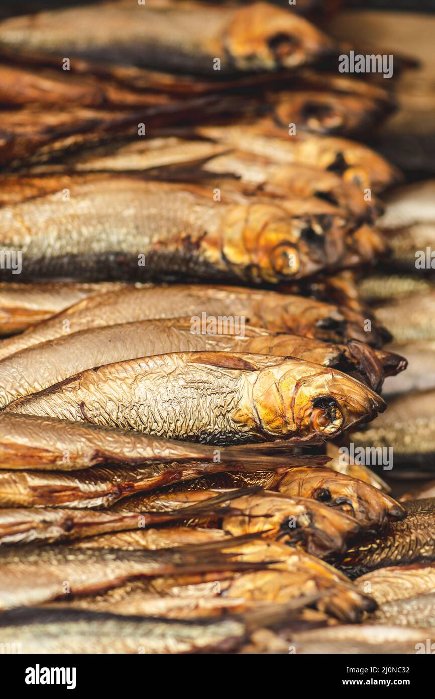 Dry smoked salted herrings in a row in a regional street food market, close up Stock Photo - Alamy