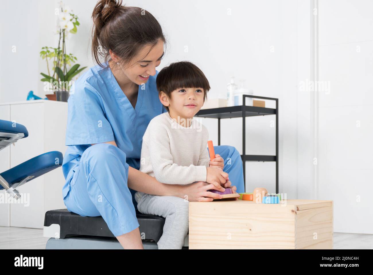 Therapist doing development activities with a little boy with with ...