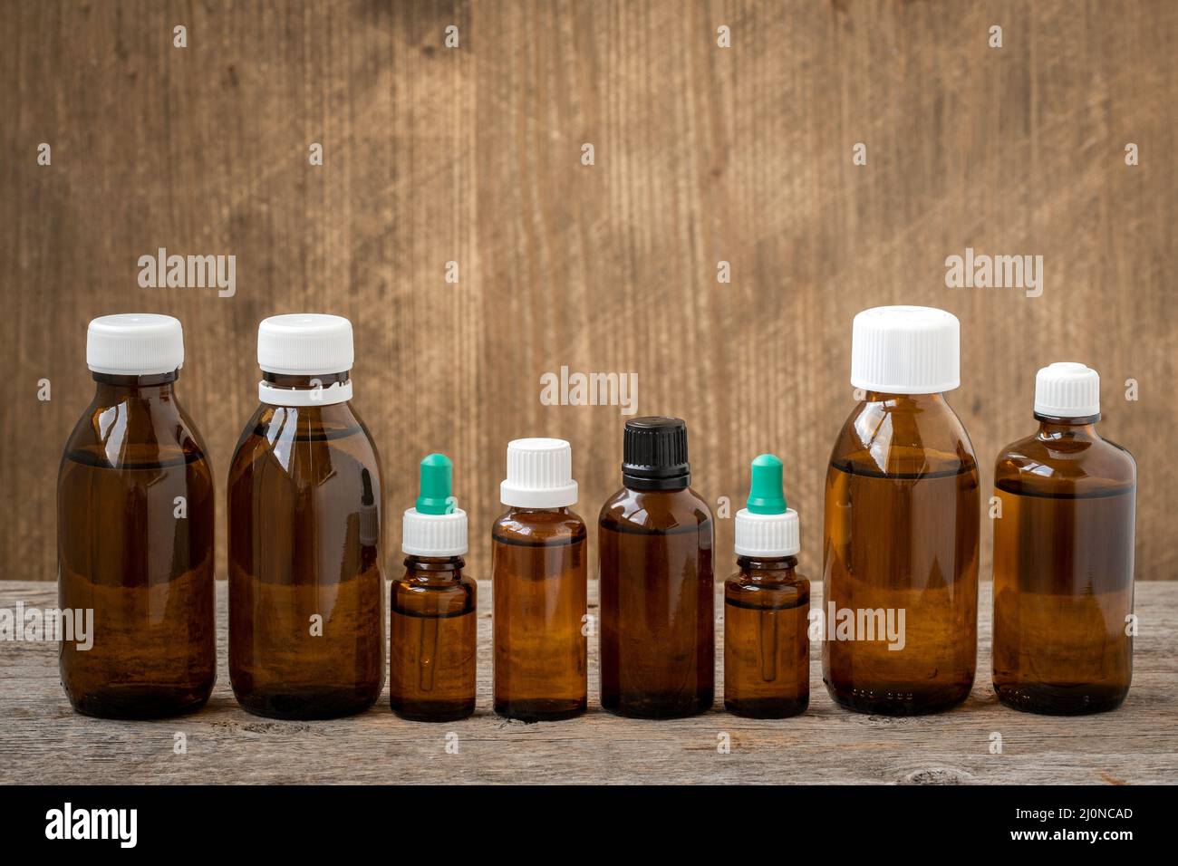 Row of small bottles with medicinal solution Stock Photo - Alamy