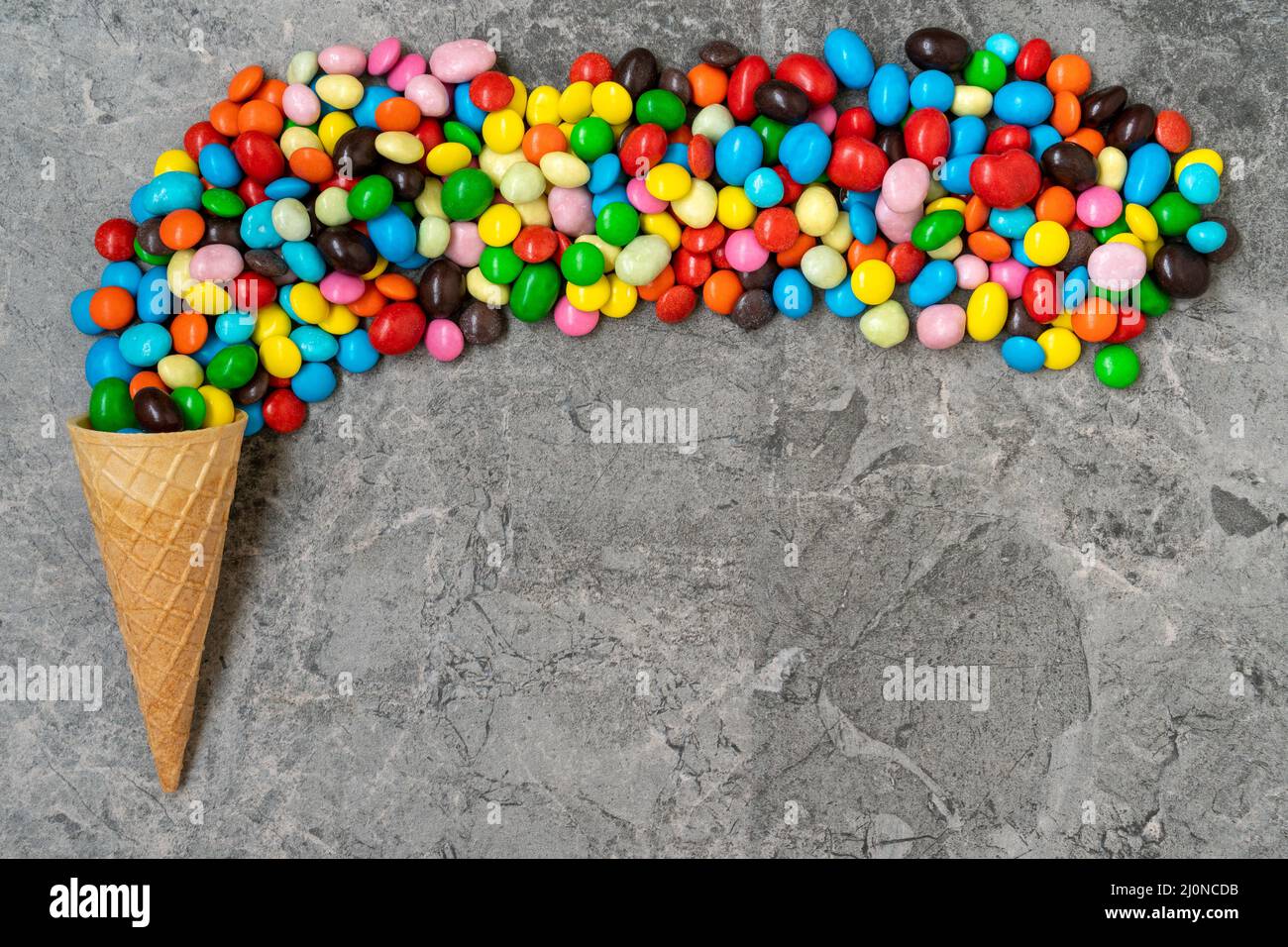 Wafer cone with colored candy Stock Photo - Alamy