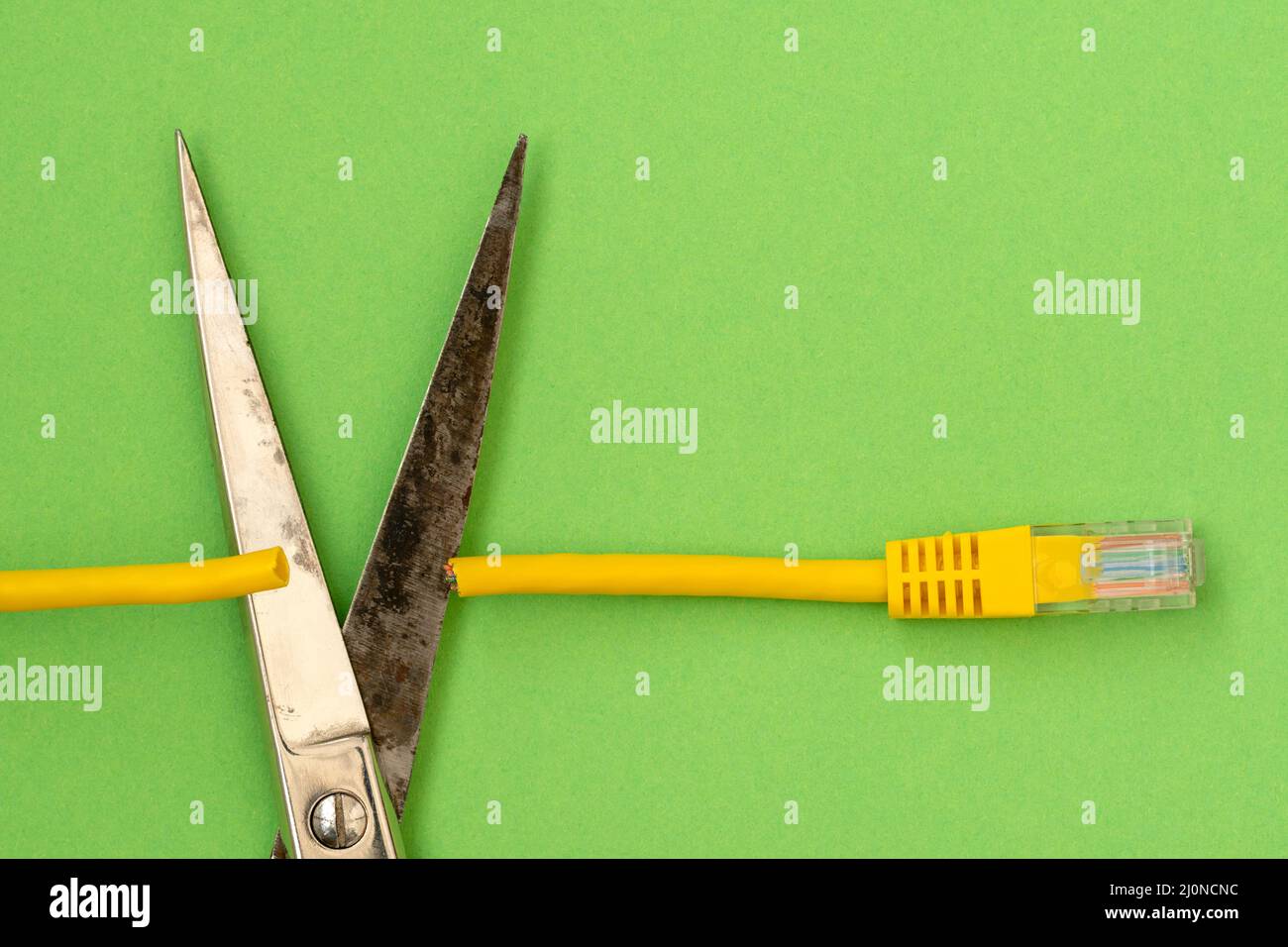 Scissors cut the yellow network cable connector Stock Photo - Alamy