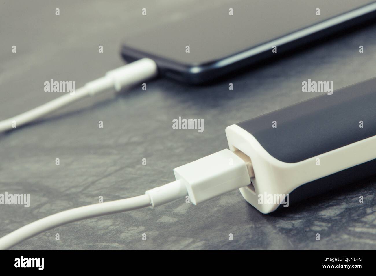 External black powerbank charging empty battery of smartphone or mobile ...