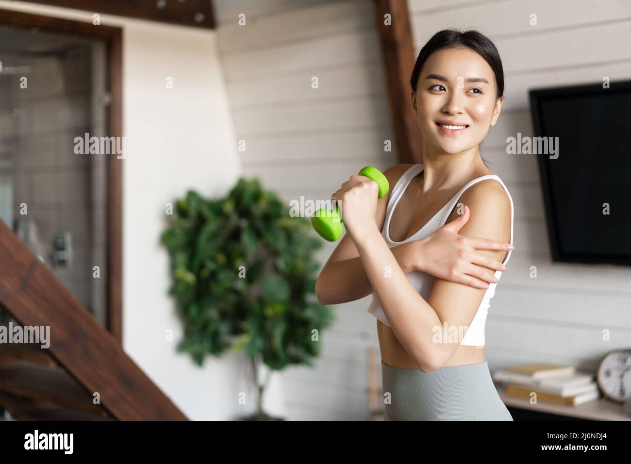 Active and healthy asian girl with fit body doing fitness exercises at ...