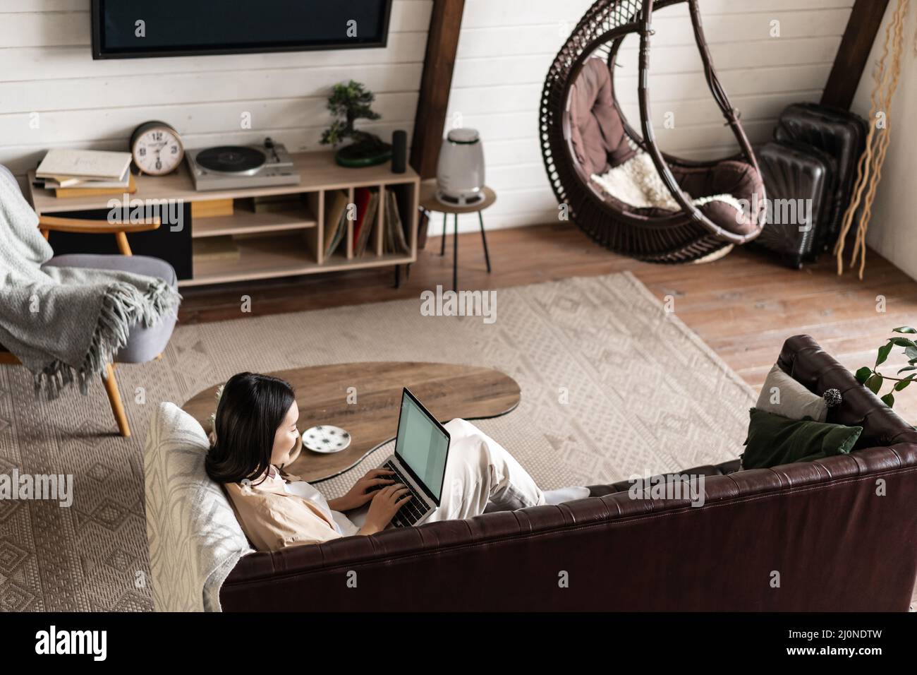 Portrait of asian woman working from home on laptop computer, sitting ...