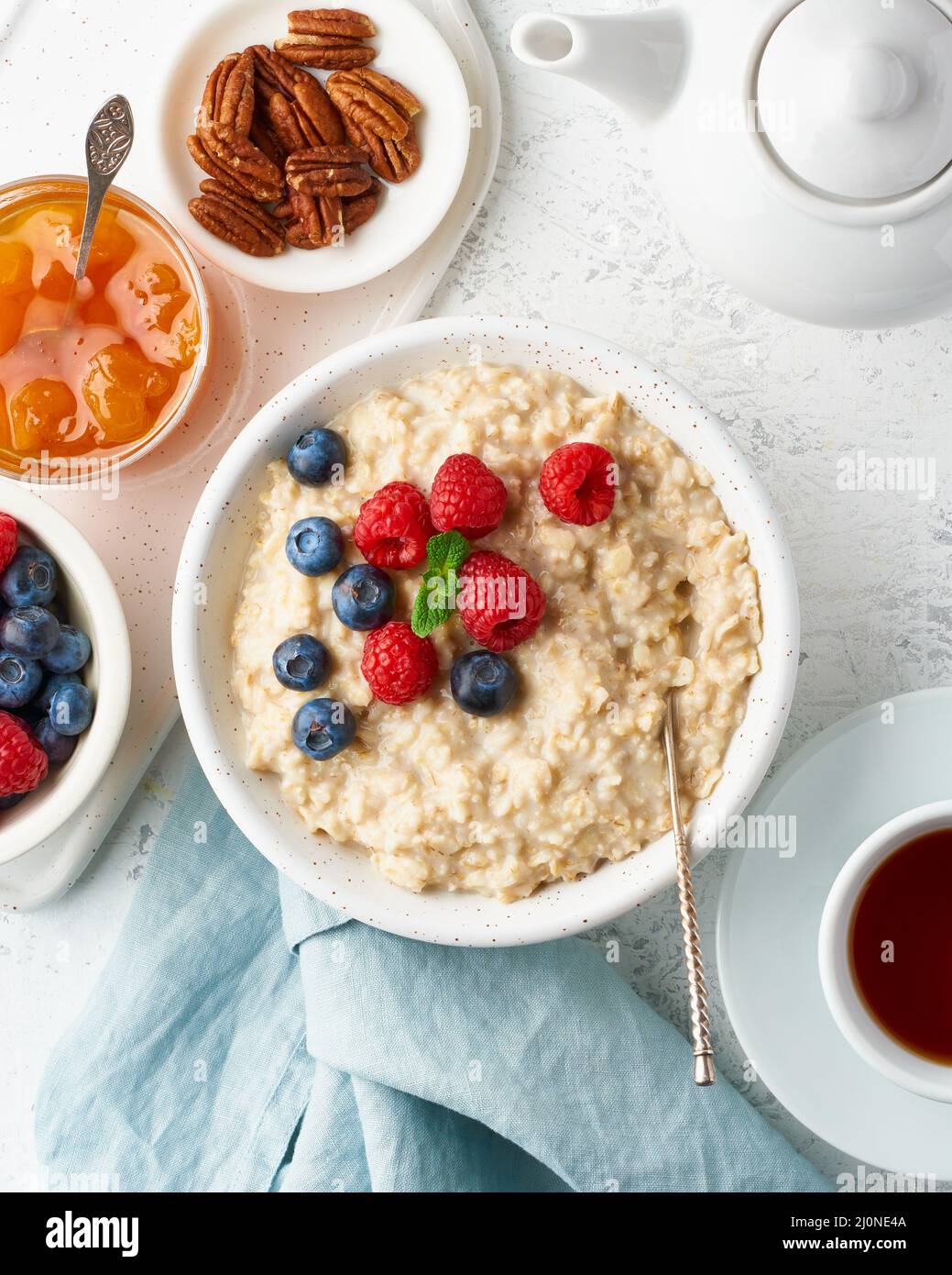 Oatmeal porridge with blueberry, raspberries, jam, vertical, top view ...