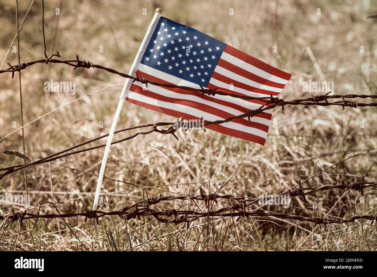 USA flag on old barbed wire fence Stock Photo - Alamy