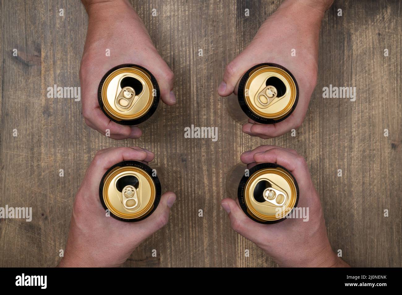 Group of friends holding beer cans Stock Photo - Alamy