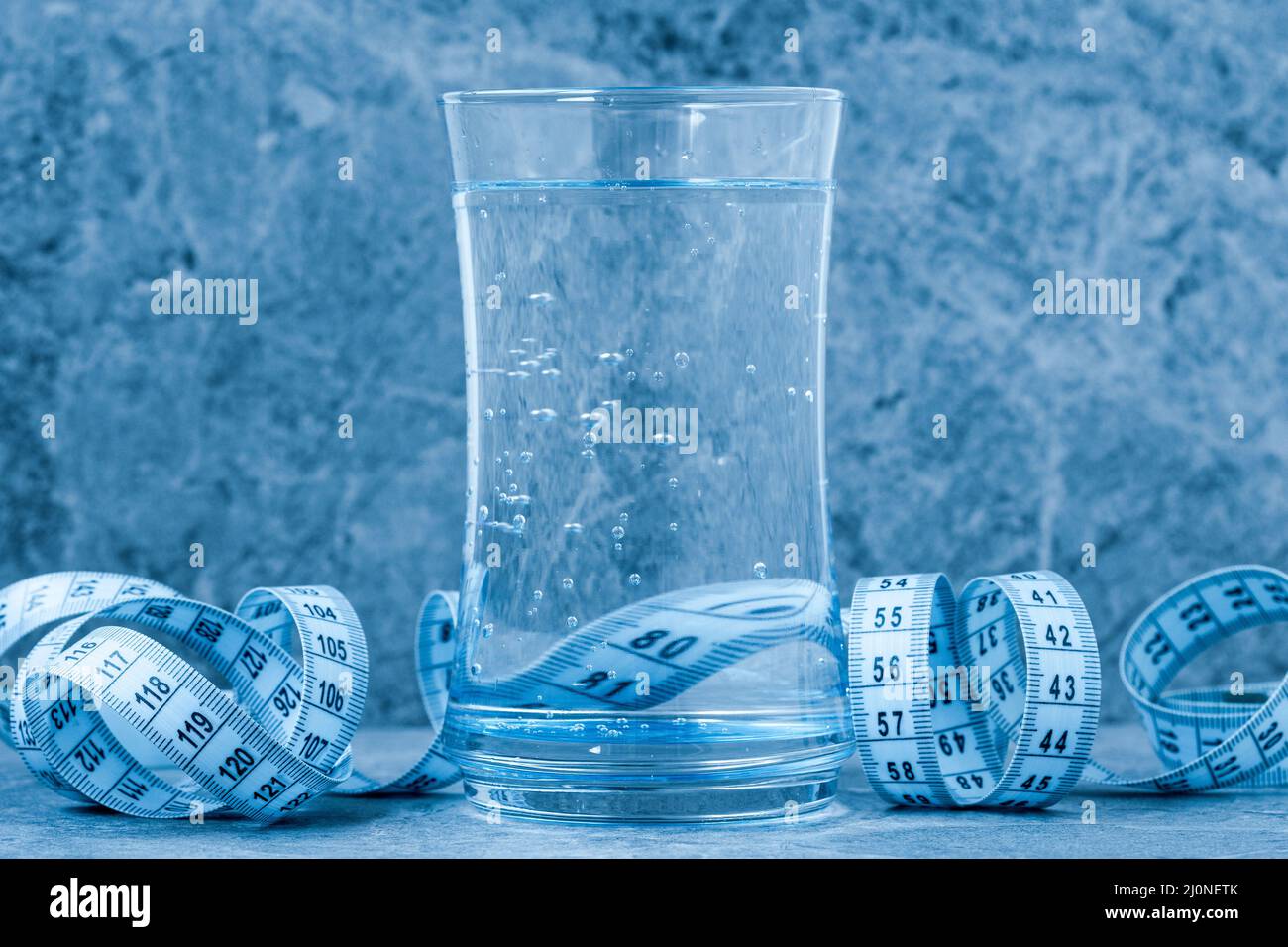 Glass of clean water with a measuring tape Stock Photo - Alamy