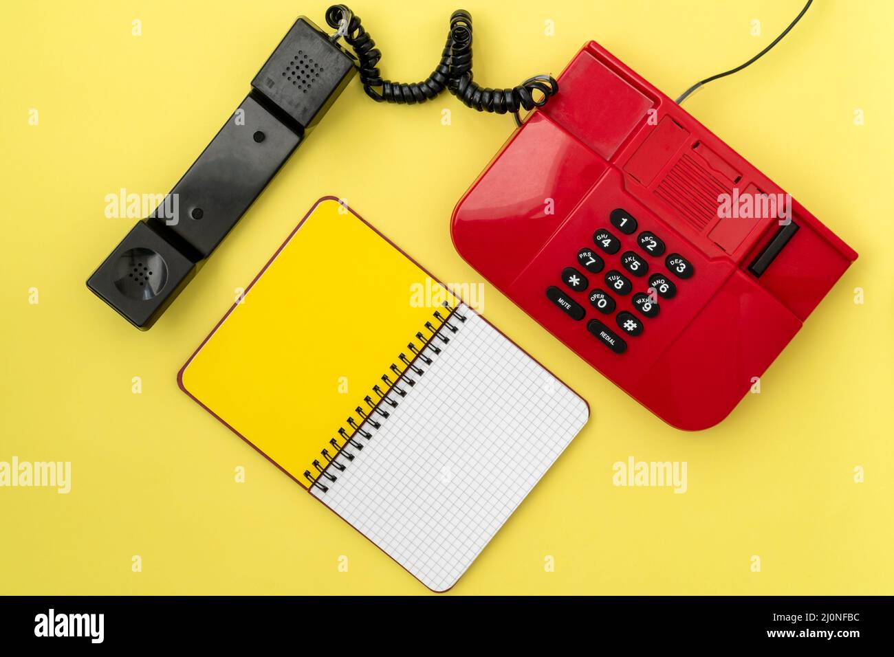 Vintage red telephone and blank notebook Stock Photo - Alamy