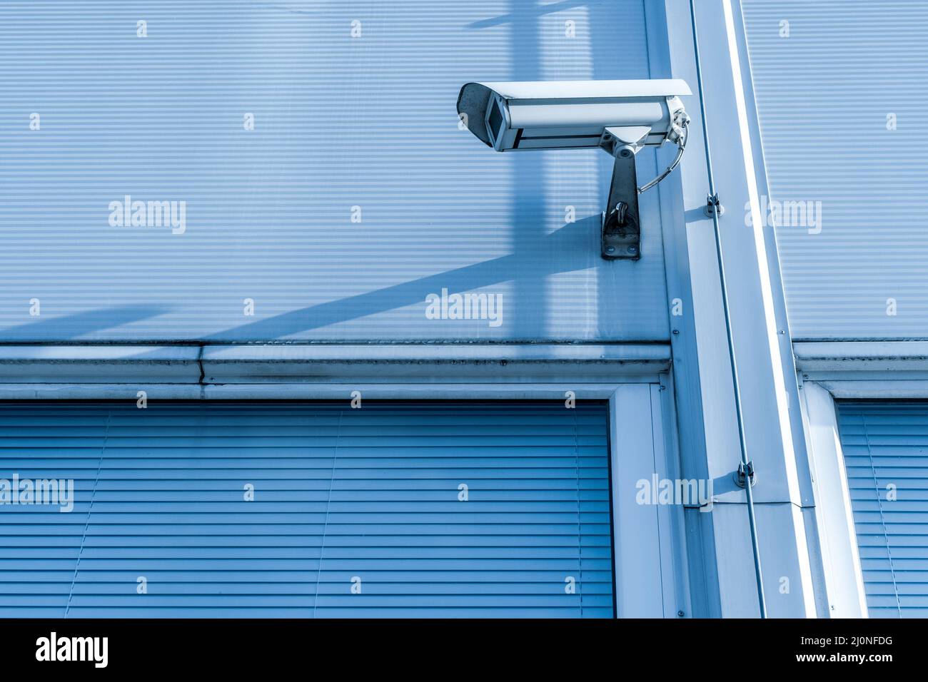 CCTV camera on the wall of industrial building Stock Photo - Alamy