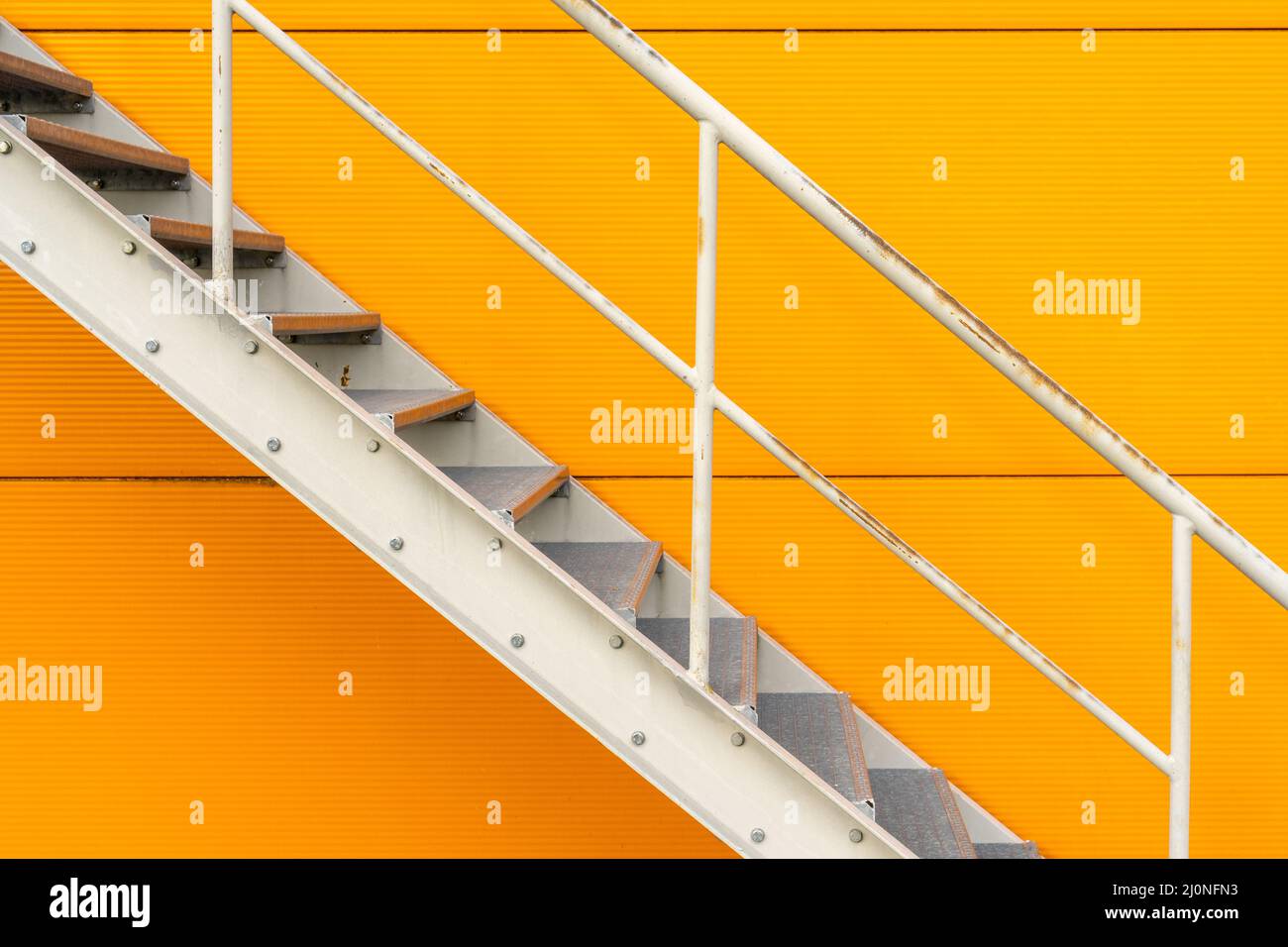Steel stairs are on the side of the building wall Stock Photo - Alamy