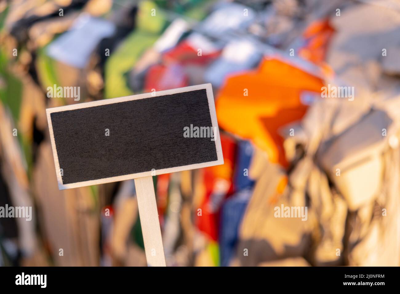 Wooden information label sign with black chalkboard against defocused ...